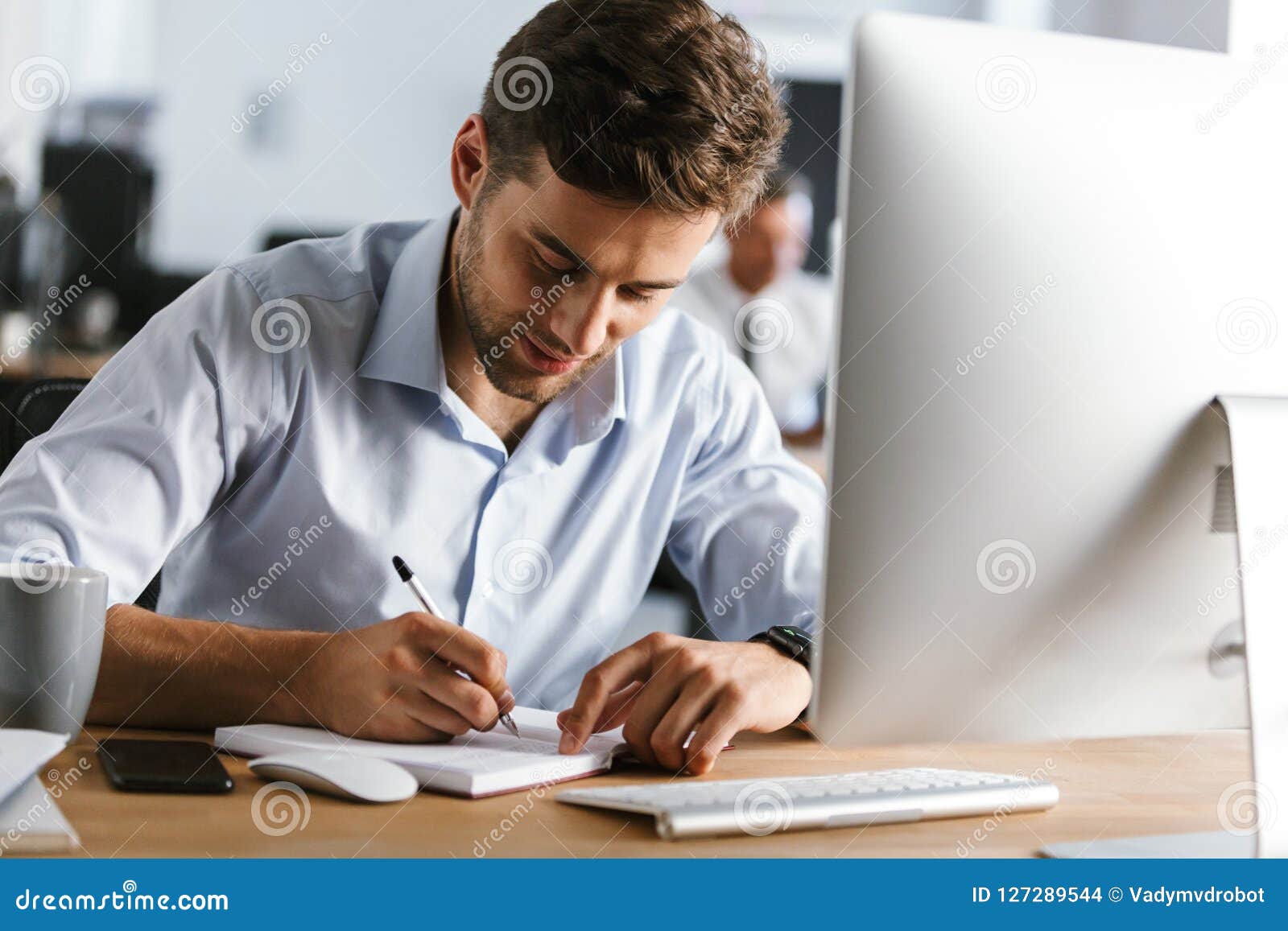 Image of Calm Male Manager Writing Something Stock Photo - Image of ...