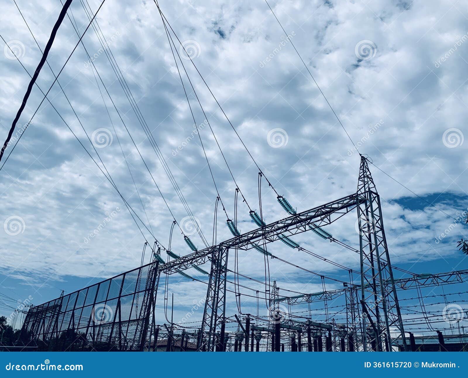 The Image Captures an Electrical Substation with a Network of High ...