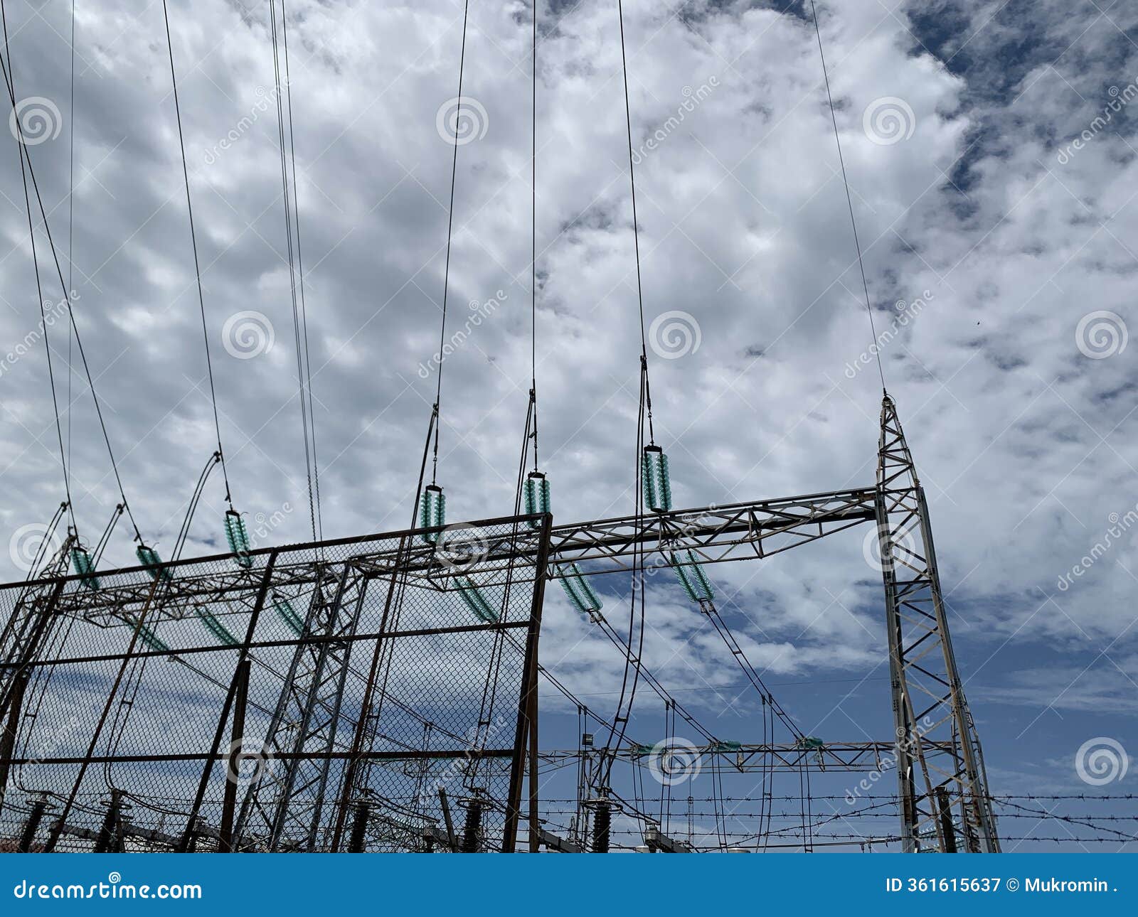 The Image Captures an Electrical Substation with a Network of High ...