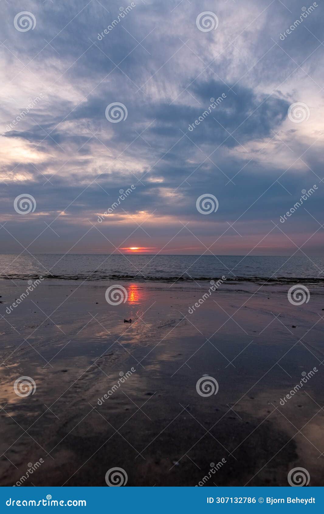 Dramatic Sky at Sunset Reflecting on Wet Beach Sands Stock Photo ...