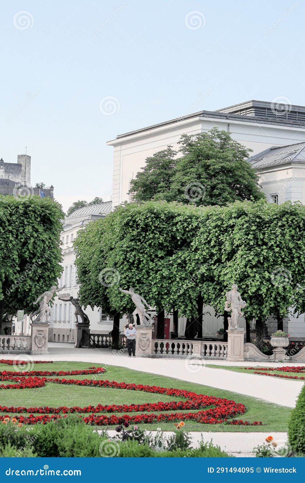A Courtyard with Many Green Trees and a Flowerbed Lined Lawn Stock ...