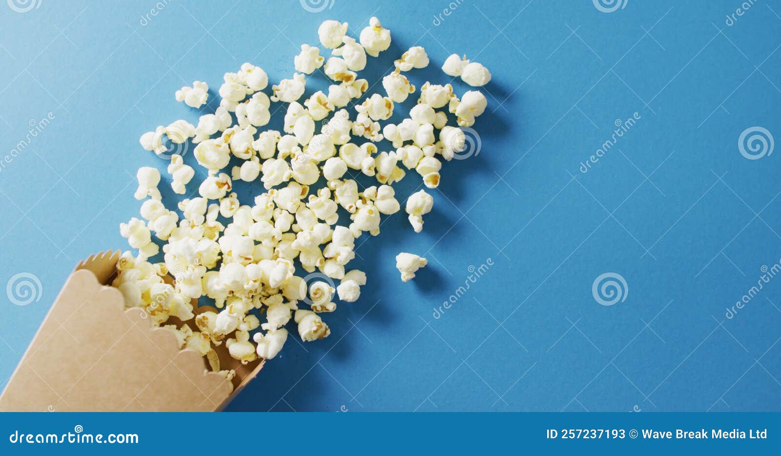 Image of Close Up of Box of Popcorn on Blue Background Stock Image ...