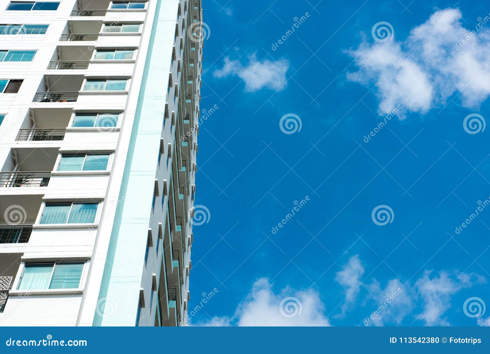 Image of Condo Building and Blue Sky Background. Stock Photo - Image of ...