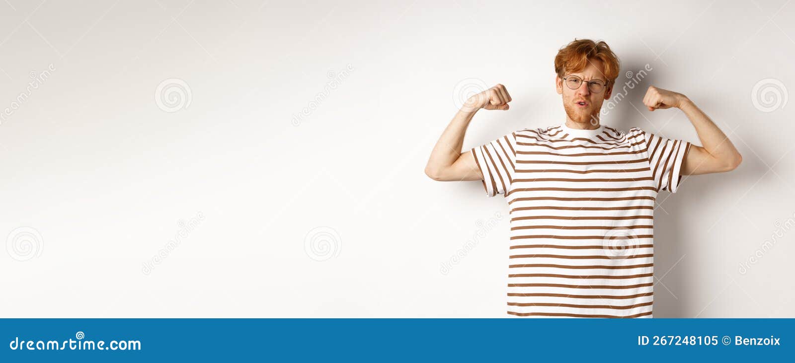 Image of Confident and Strong Redhead Man Flexing Biceps, Showing ...