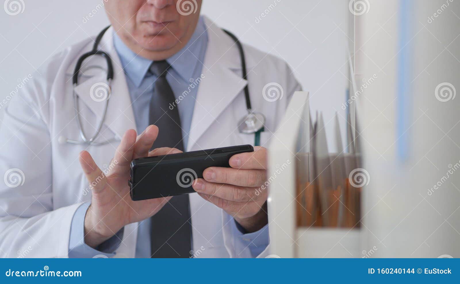 Image with a Doctor Texting on Cellphone in Hospital Cabinet Stock ...