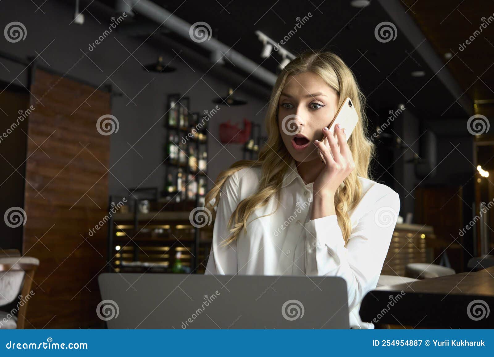 Image of a Emotionally Blonde Woman Posing Sitting Indoors at Caffe ...