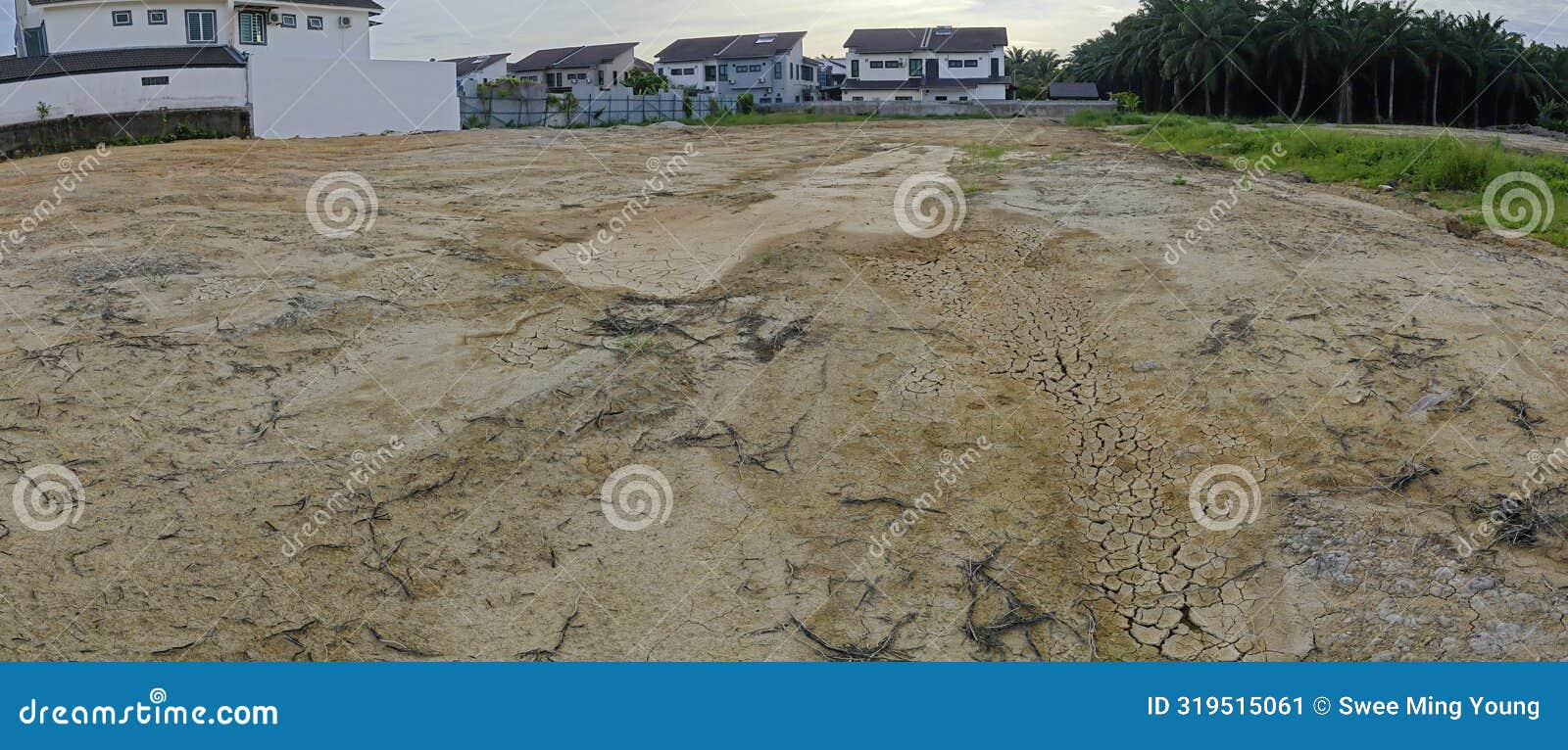 An Empty Plot of Land Scene Besides a Residential Row of Houses. Stock ...