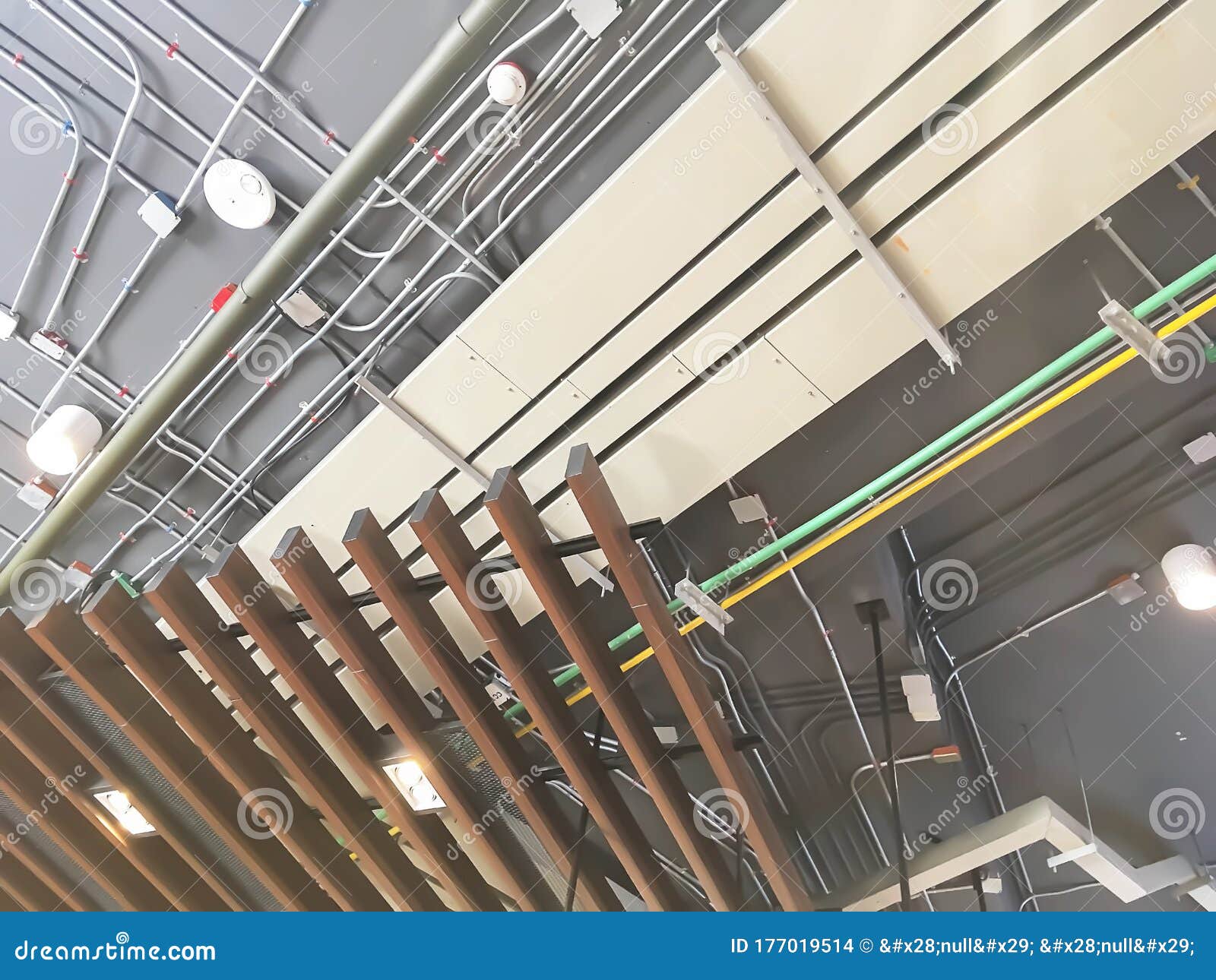 Image of Exposed Mechanical System Installation Above Wooden Striped ...