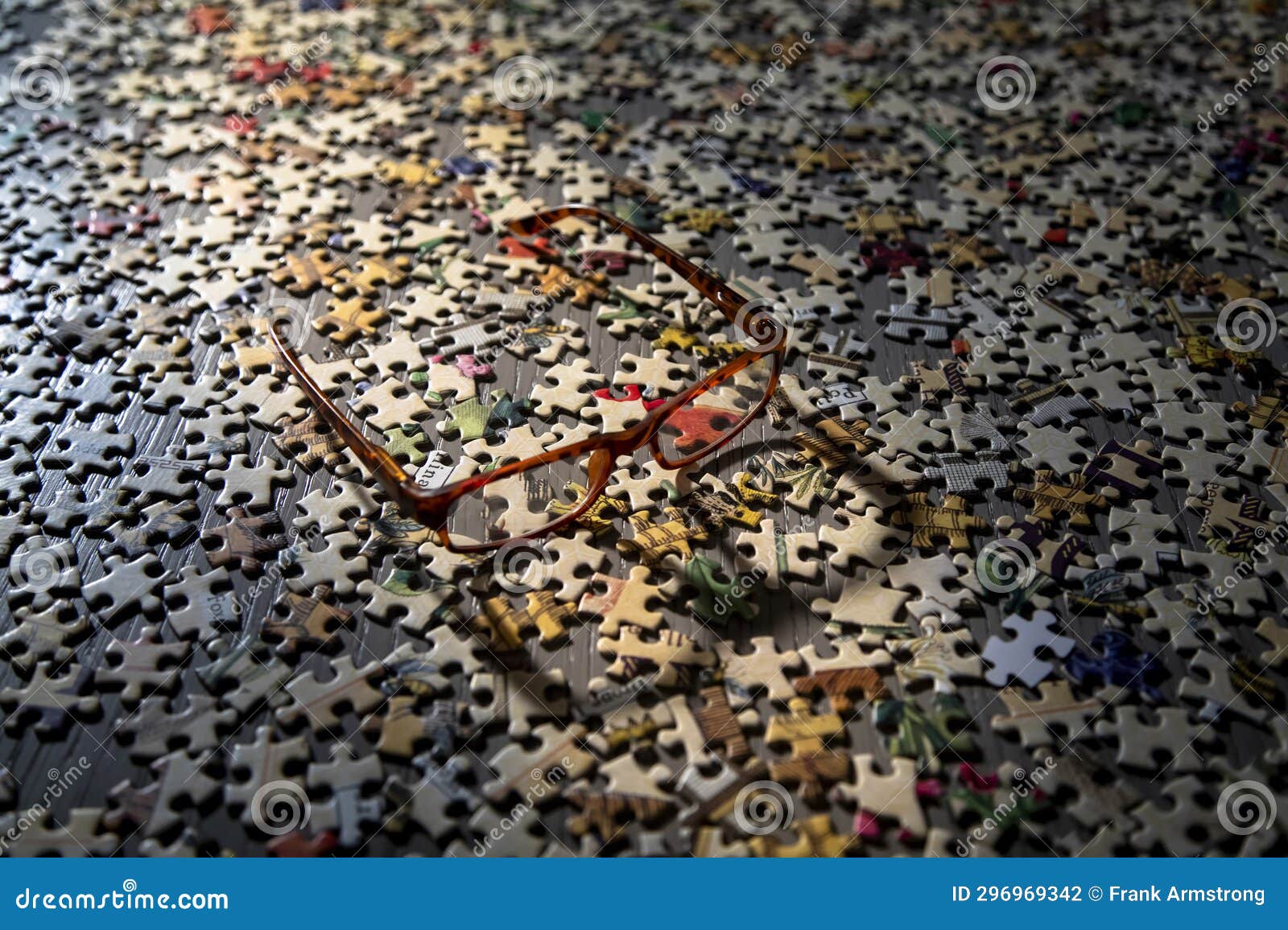 Image of Eye Glasses Casting a Shadow on a Large Group of Puzzle Pieces ...