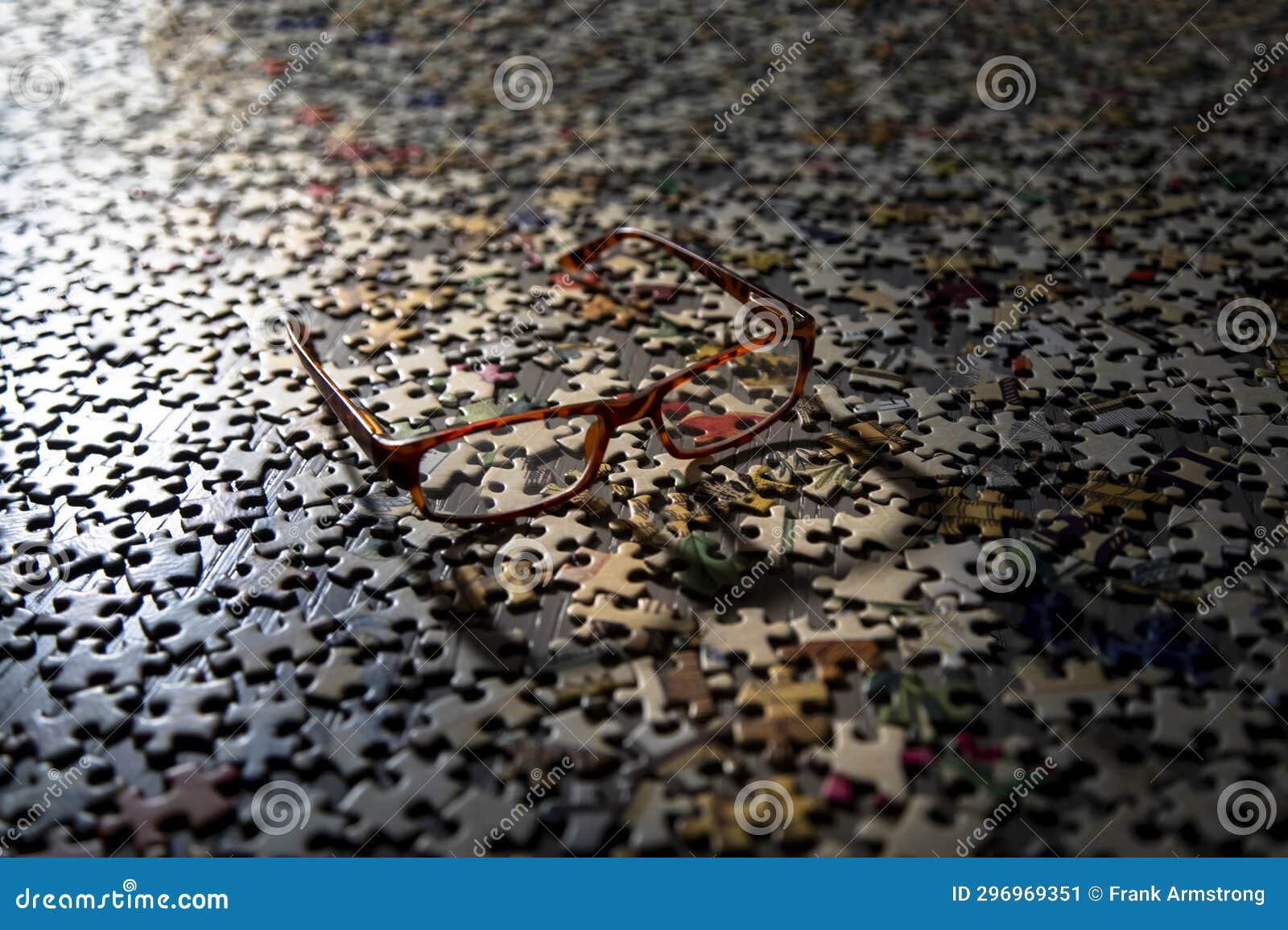 Image of Eye Glasses Casting a Shadow on a Large Group of Puzzle Pieces ...