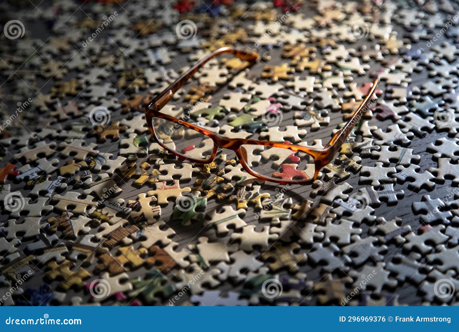 Image of Eye Glasses Casting a Shadow on a Large Group of Puzzle Pieces ...
