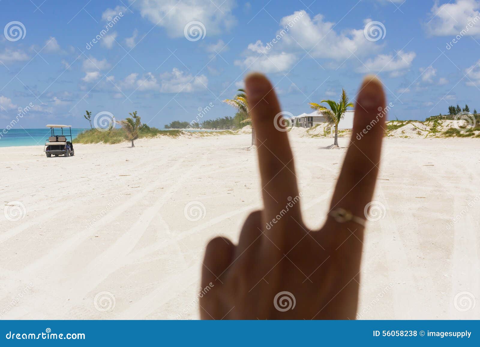 Image of Fingers Making the Peace Sign on the Beach Stock Photo - Image ...