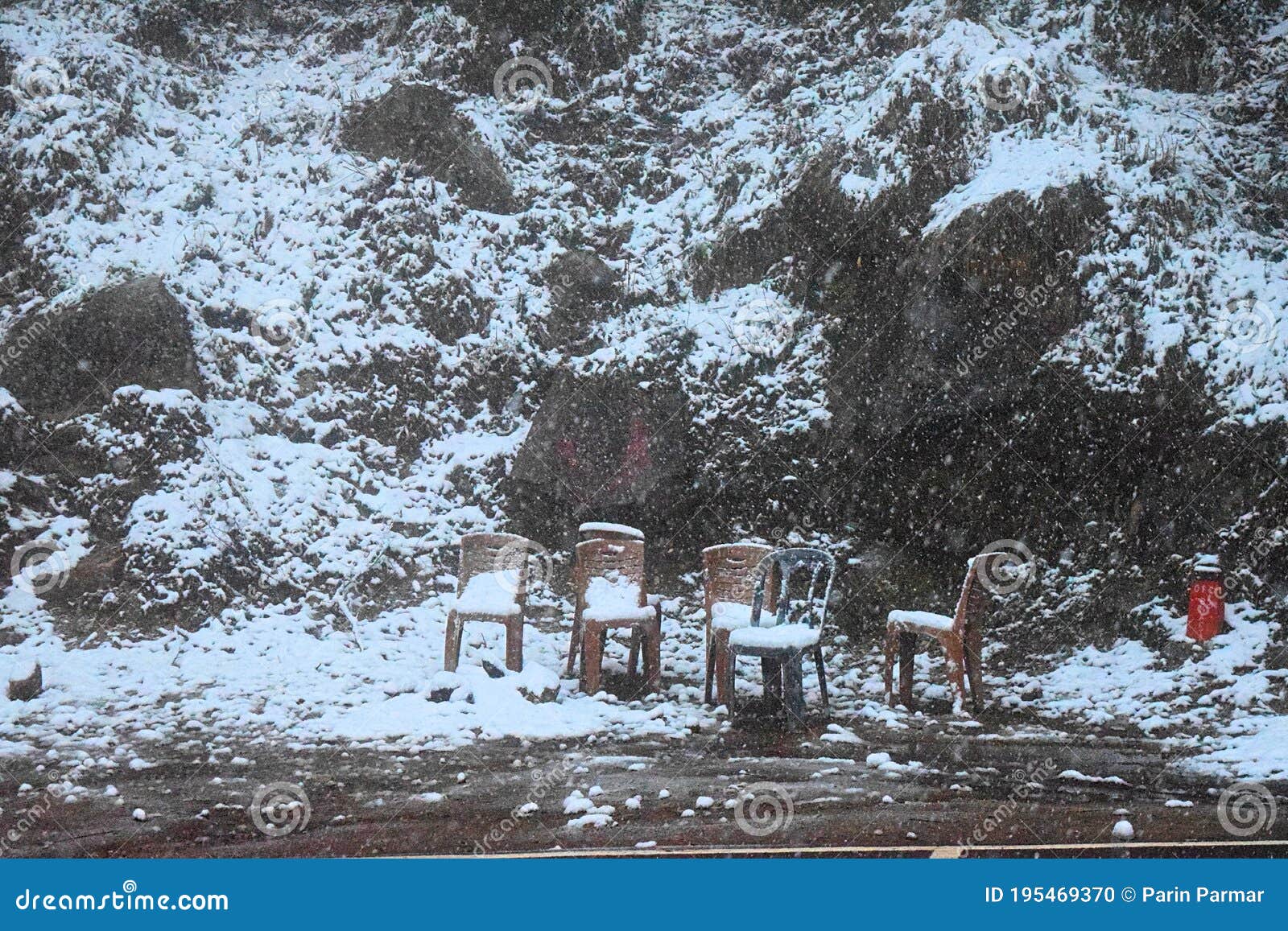 Empty Chairs, Ground, and Hill Covered by Snow - Active Snow Fall ...