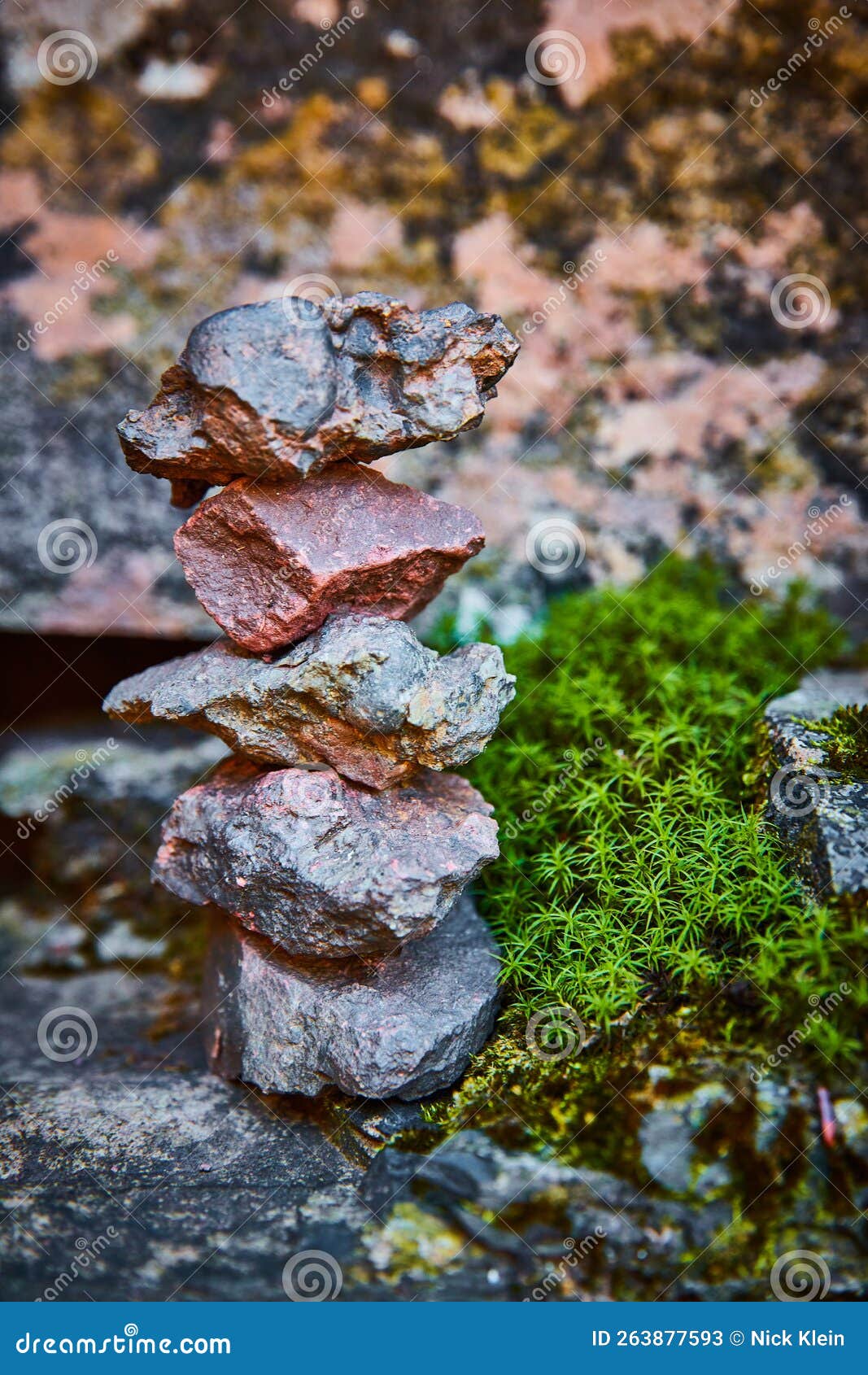 Focus on Cairn Stone Stack of Tiny Rocks Nested Against Mossy Rocks and ...