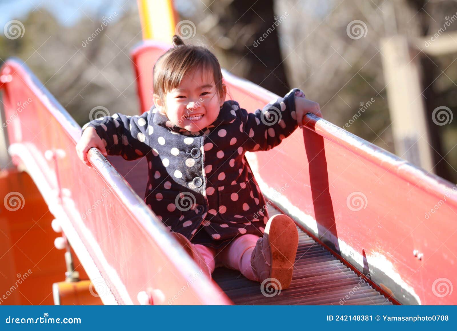 Girl playing on the slide stock image. Image of asia - 242148381