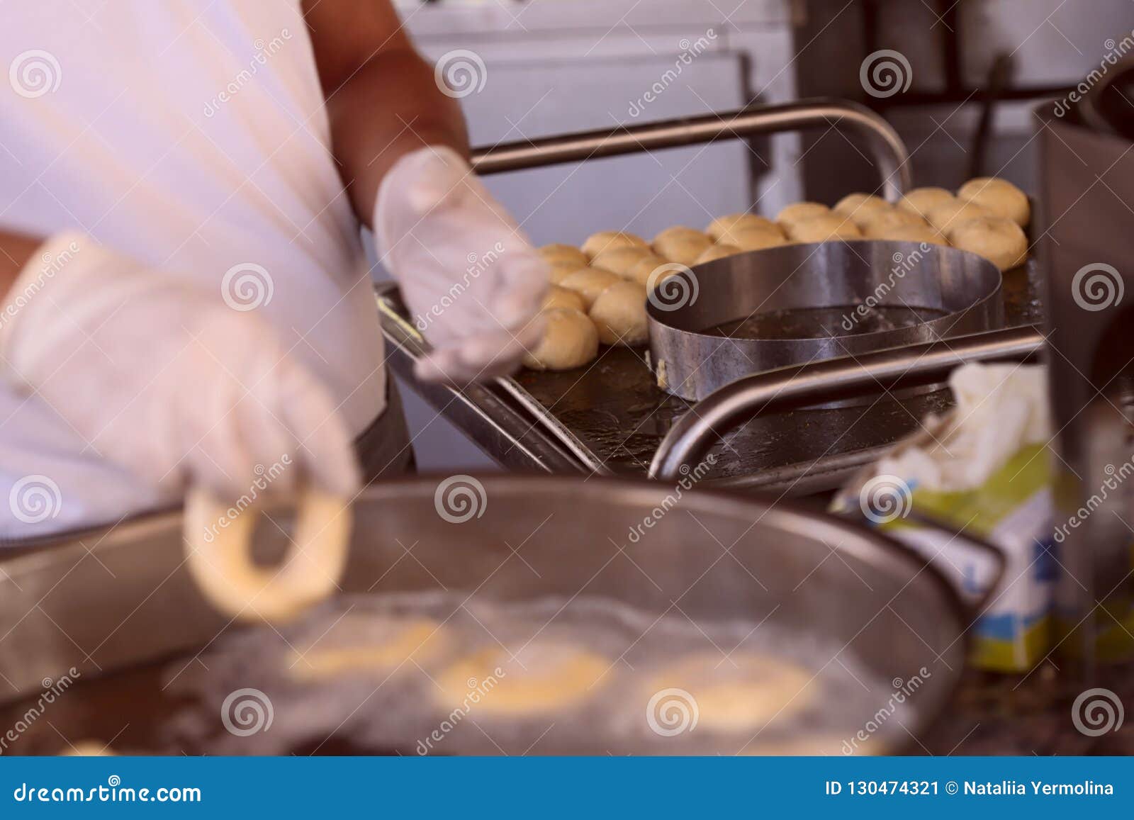 The Image of the Hands of the Cook Men. the Process of Cooking Donuts ...