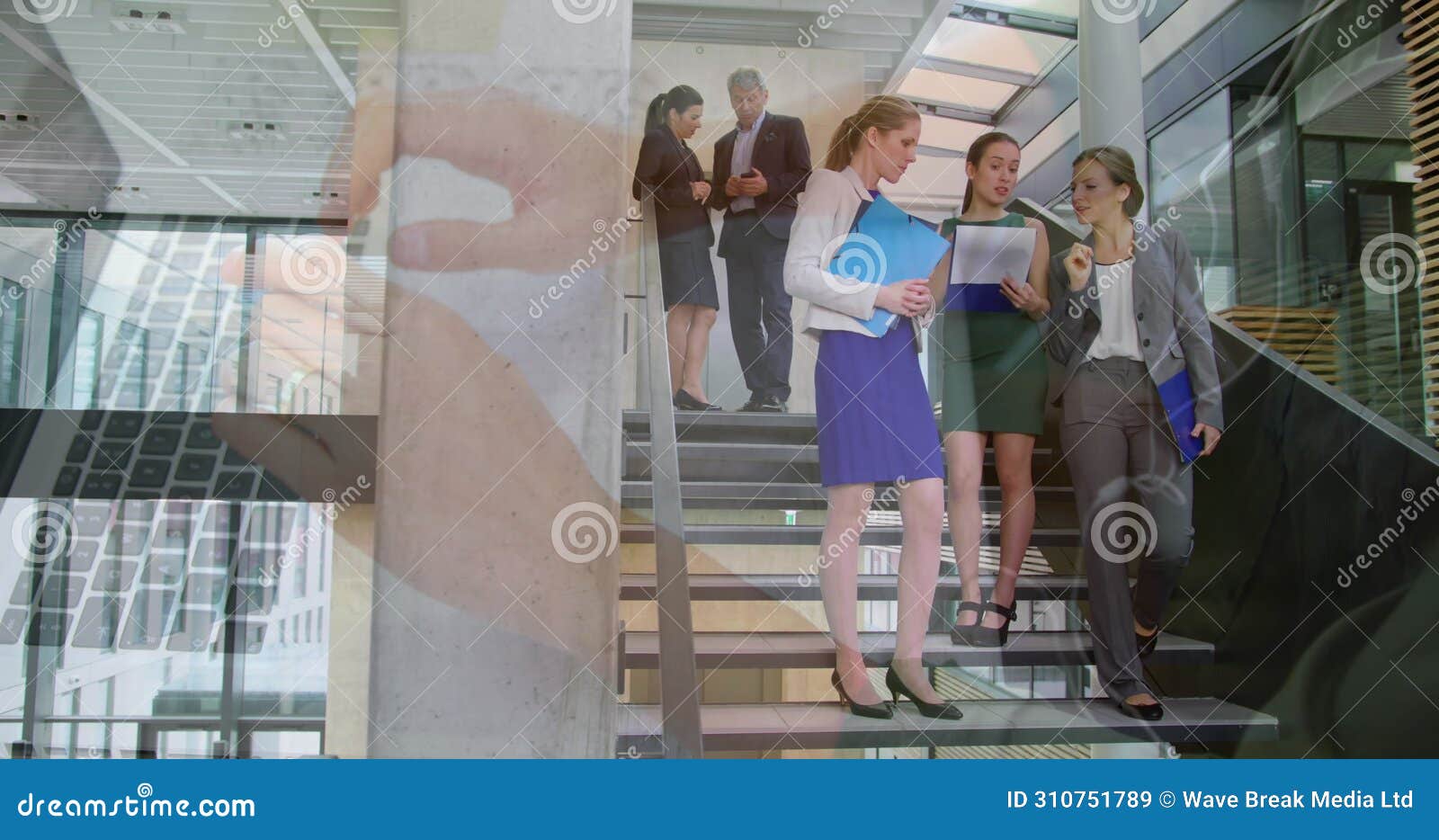Image of Hands of Man Using Laptop Over Business Colleagues Walking ...