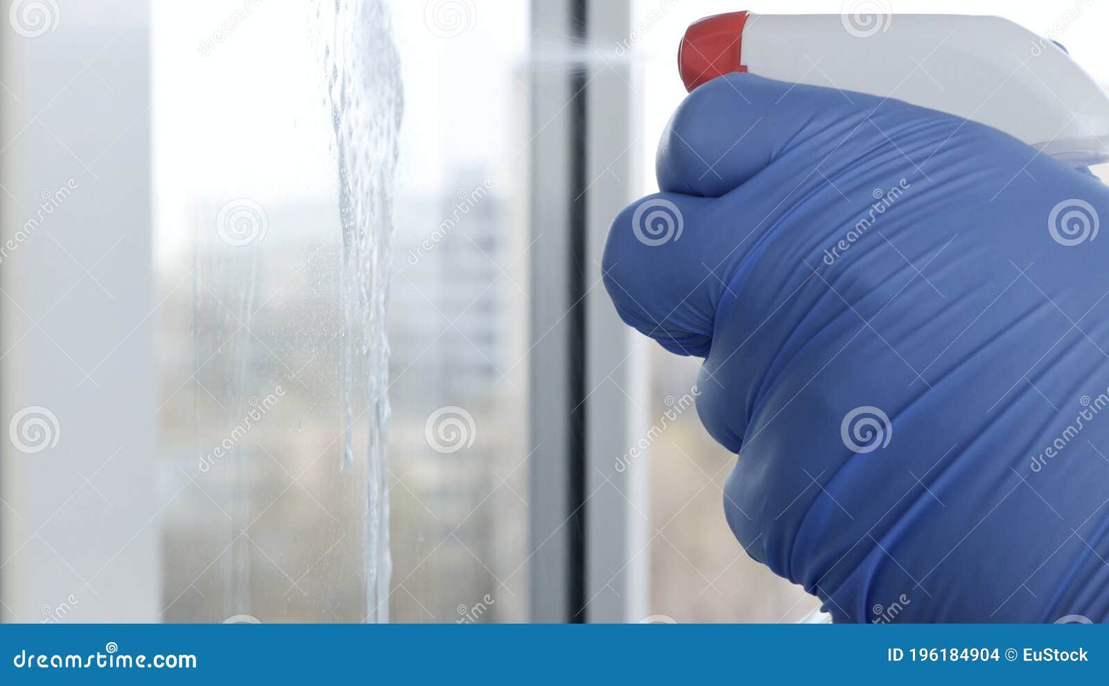 Image with Hands Wearing Protective Gloves Cleaning a Window Using ...