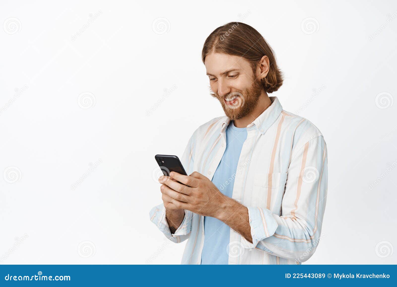 Image of Handsome Caucasian Guy Using Mobile Phone, Looking at ...