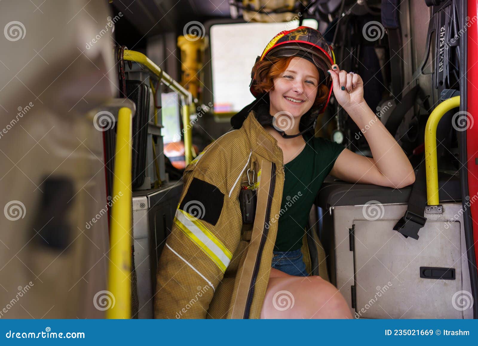 Image of Happy Ginger Firewoman Looking in Camera Sitting in Cab of ...