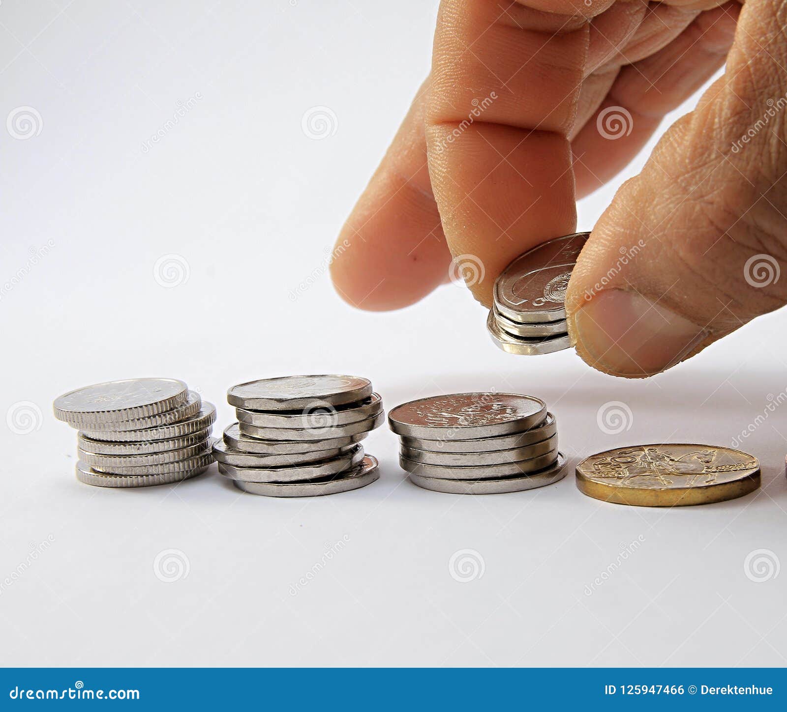 Image of Coins Piled Up on White Surface Stock Photo - Image of ...