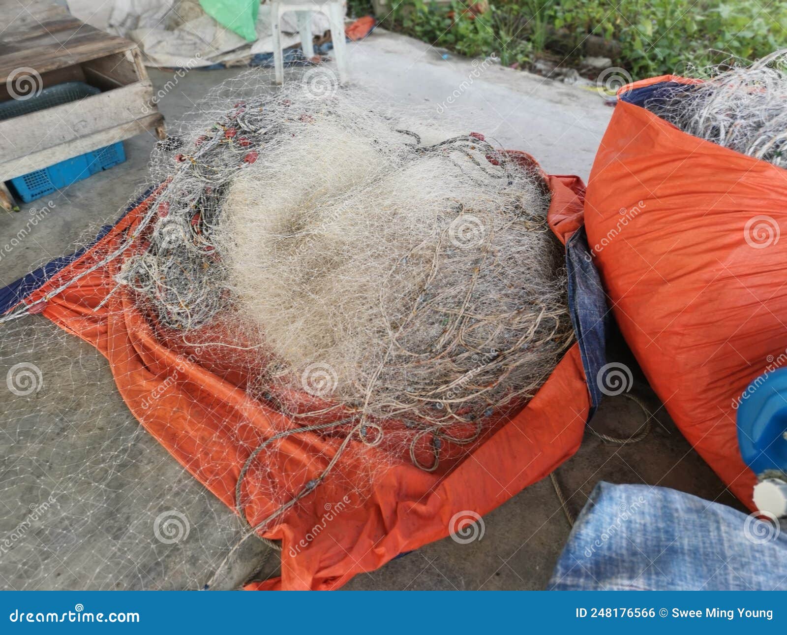 Knitting Fishing Net and Tool on the Ground. Stock Photo - Image of ...