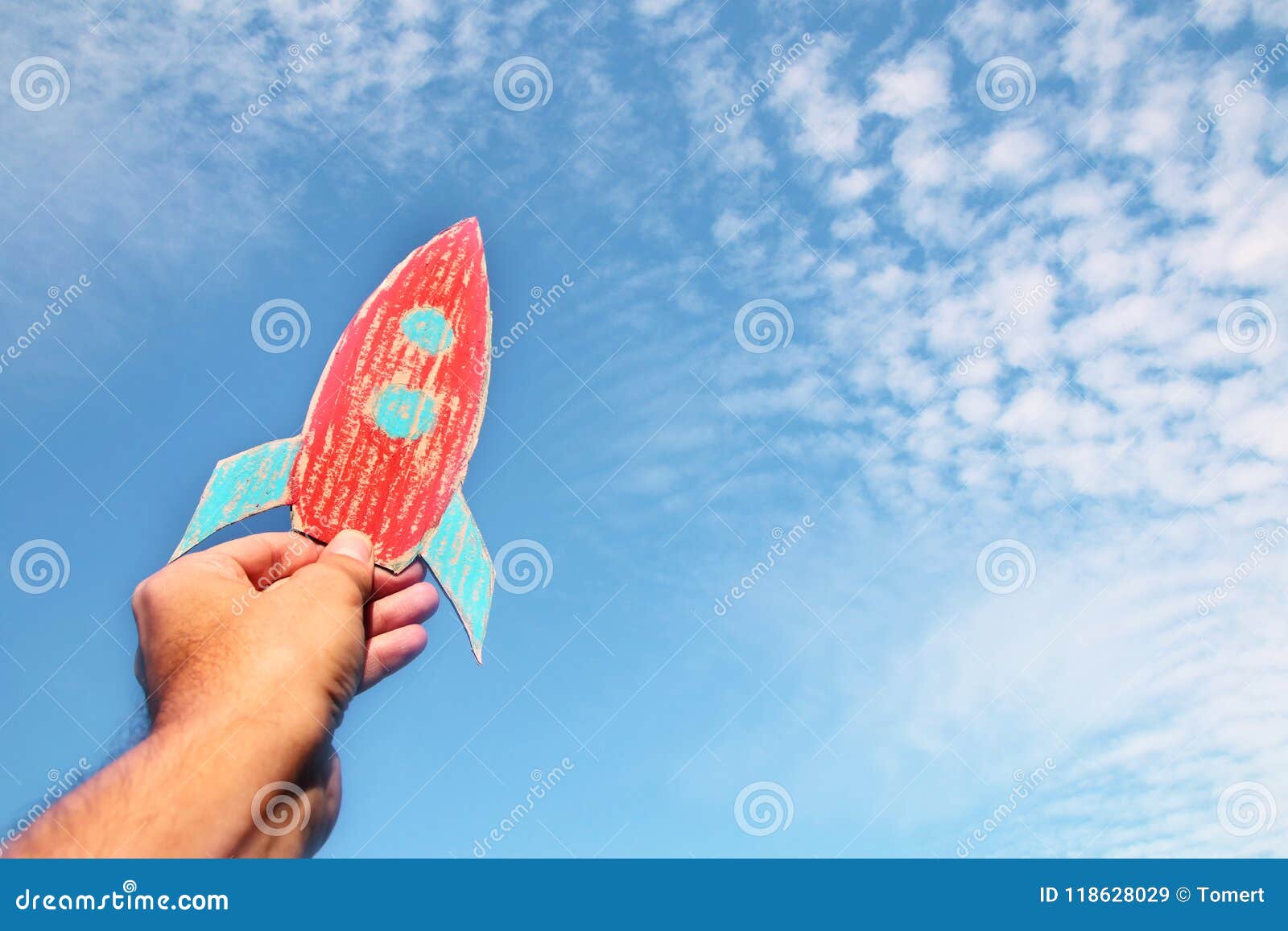 Image of Male Hand Holding a Rocket Against the Sky. Imagination and ...