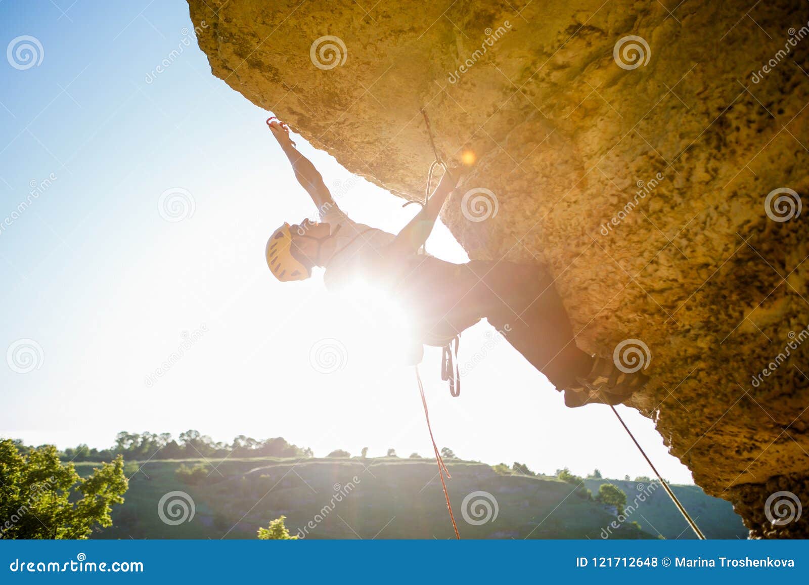 Image of Man Climber in Helmet Clambering Up Cliff. Stock Photo - Image ...