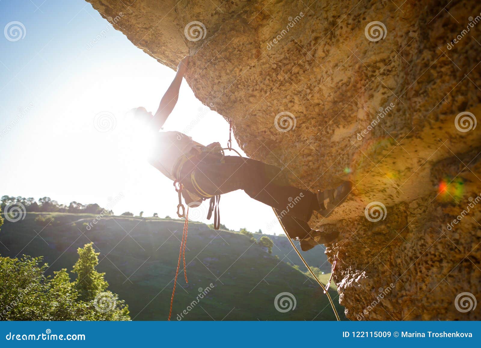 Image of Man Climber in Helmet Clambering Up Cliff. Stock Image - Image ...