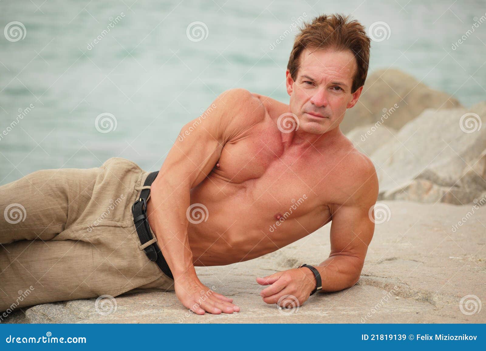 Image of a Man Laying on the Rocks Stock Image - Image of outdoors ...