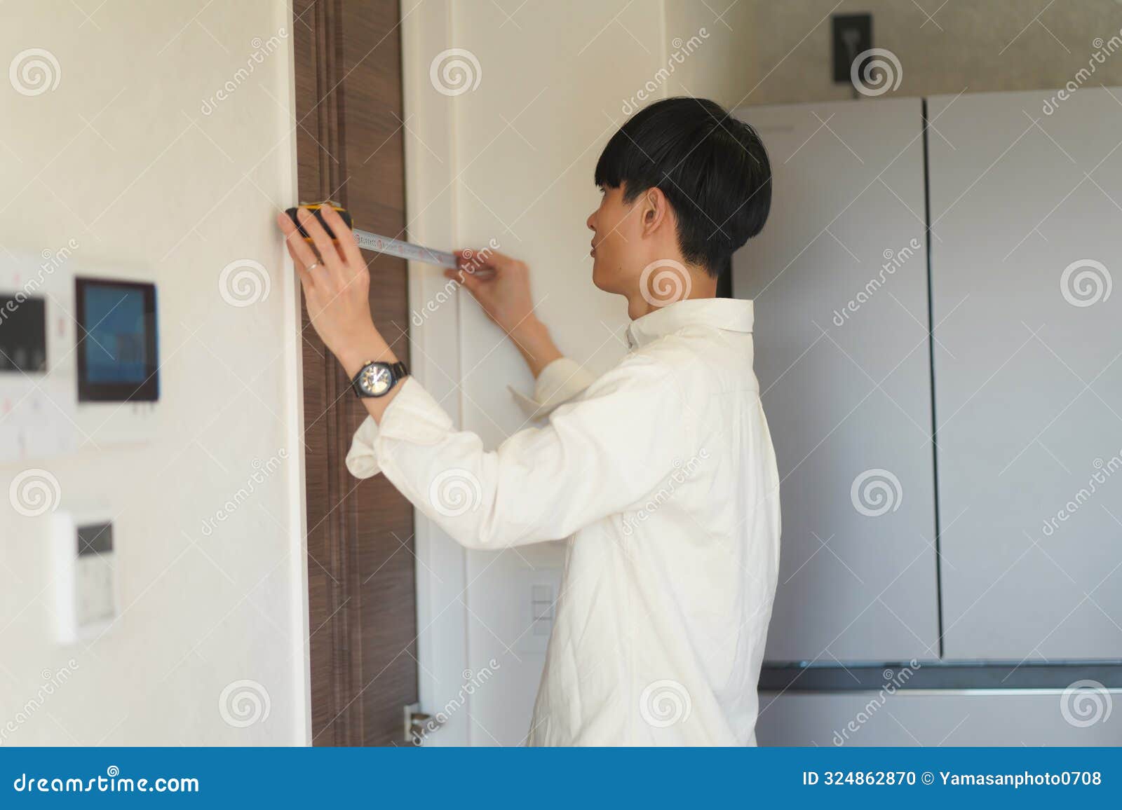 A Man Measuring the Height of a Room Stock Photo - Image of preparation ...