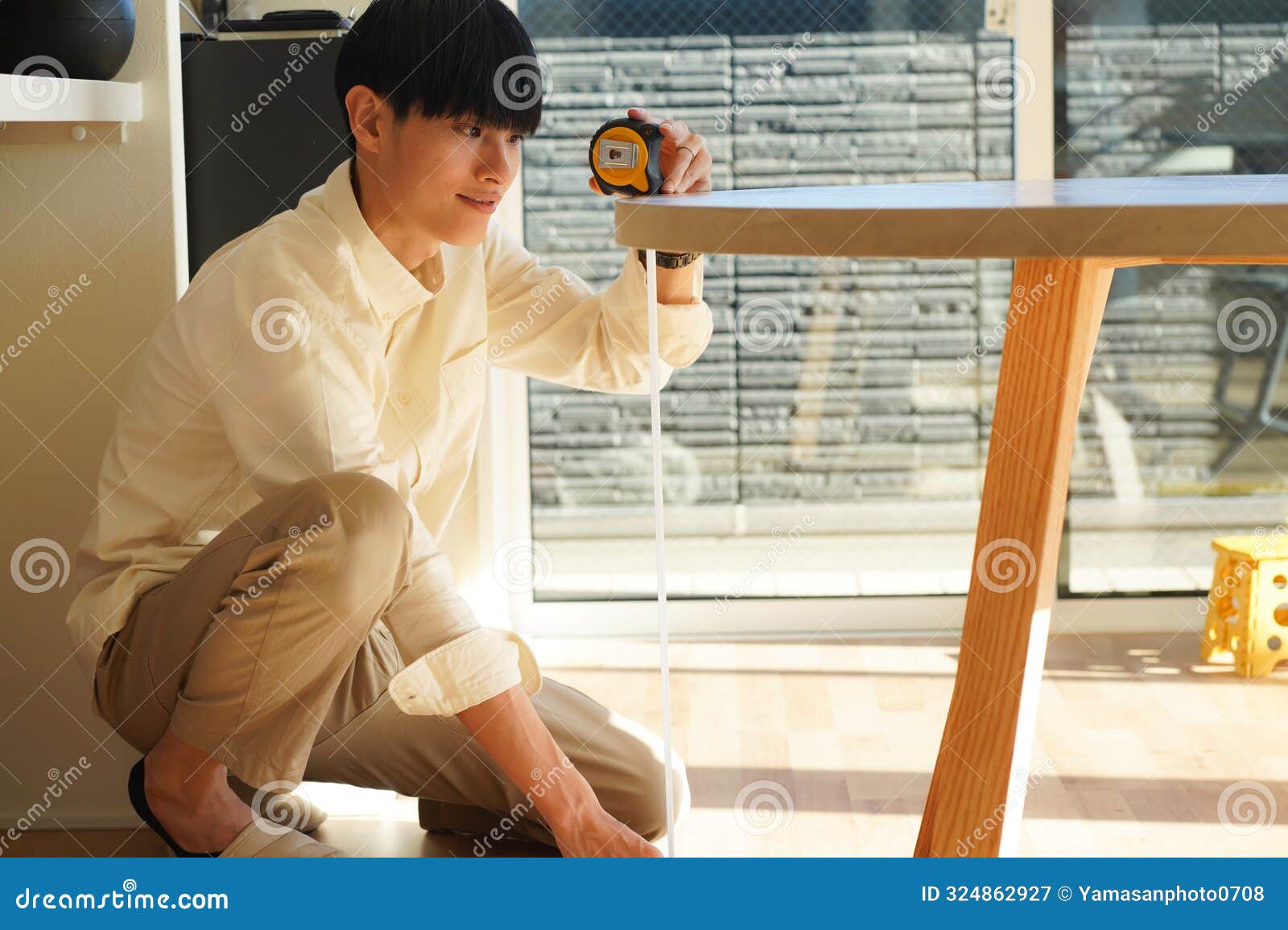 Man Measuring the Height of a Table Stock Image - Image of lifestyle ...