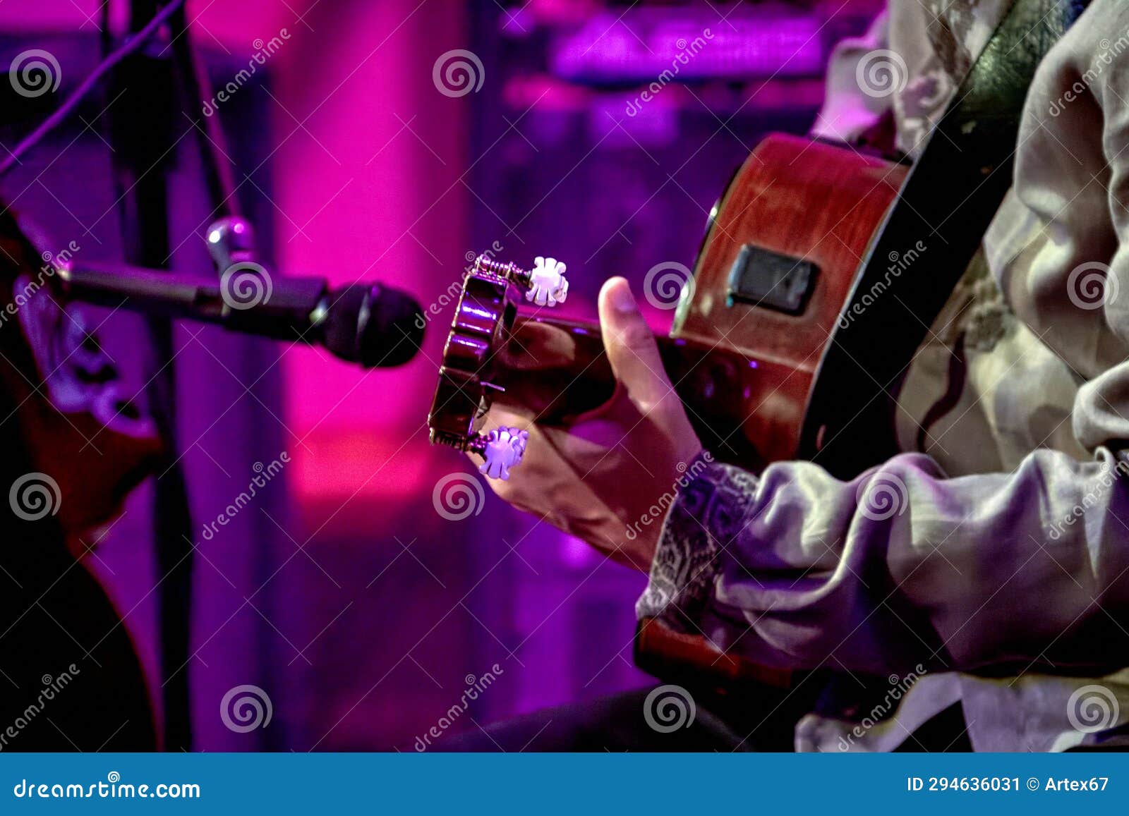 Man Playing an Acoustic Guitar in Front of a Microphone Stock Image ...