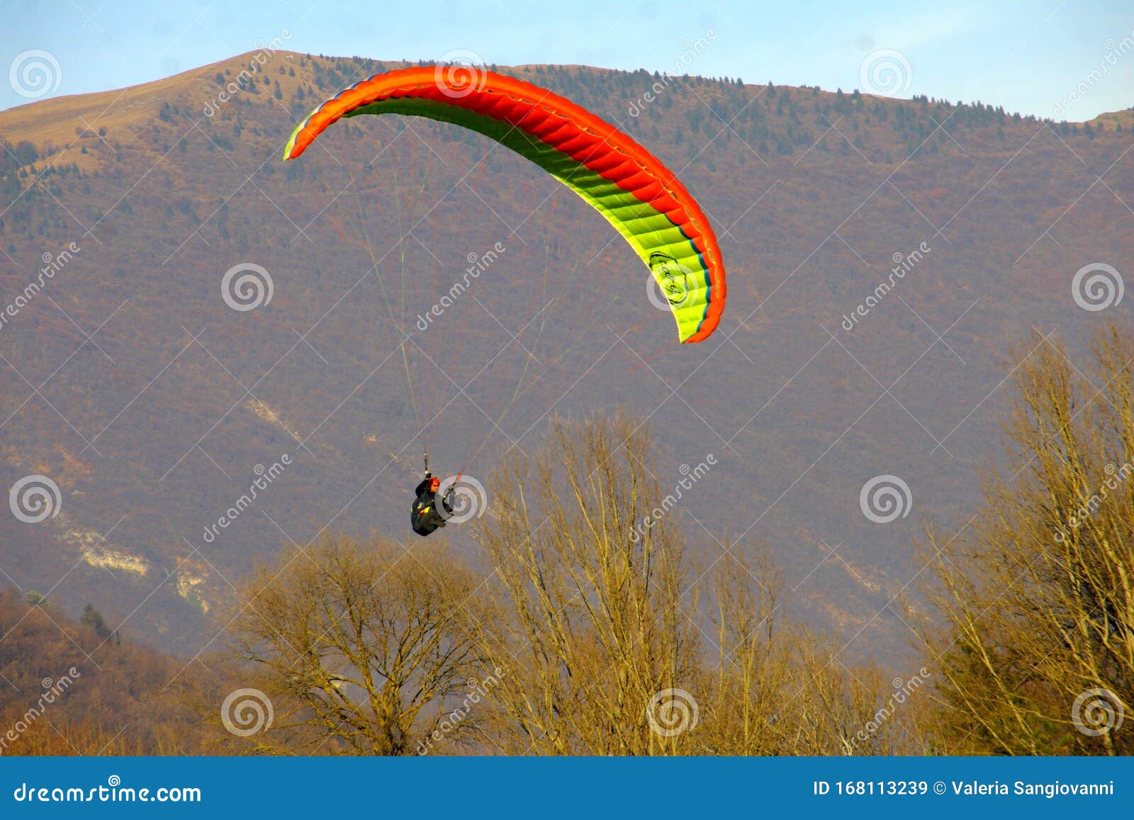 Image of Man Practicing Parachuting Over Mountain Landscape Stock Image ...