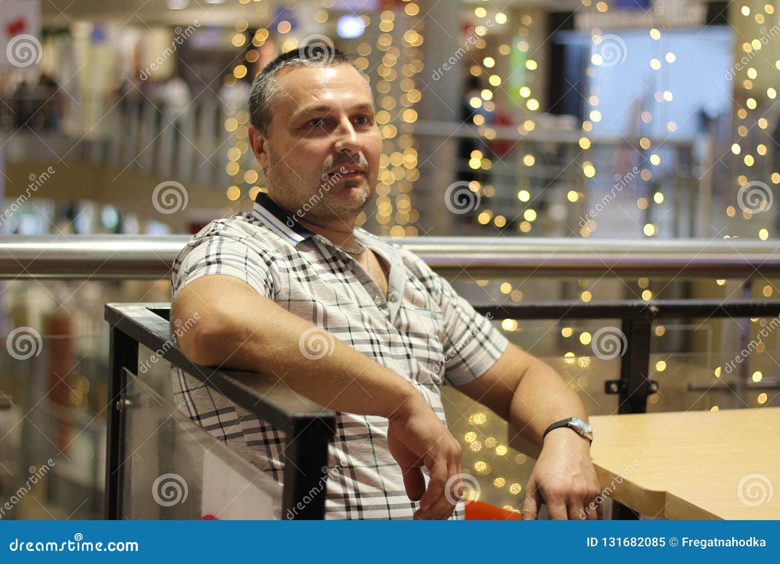 A Man Sitting at a Table in a Cafe Stock Image - Image of background ...
