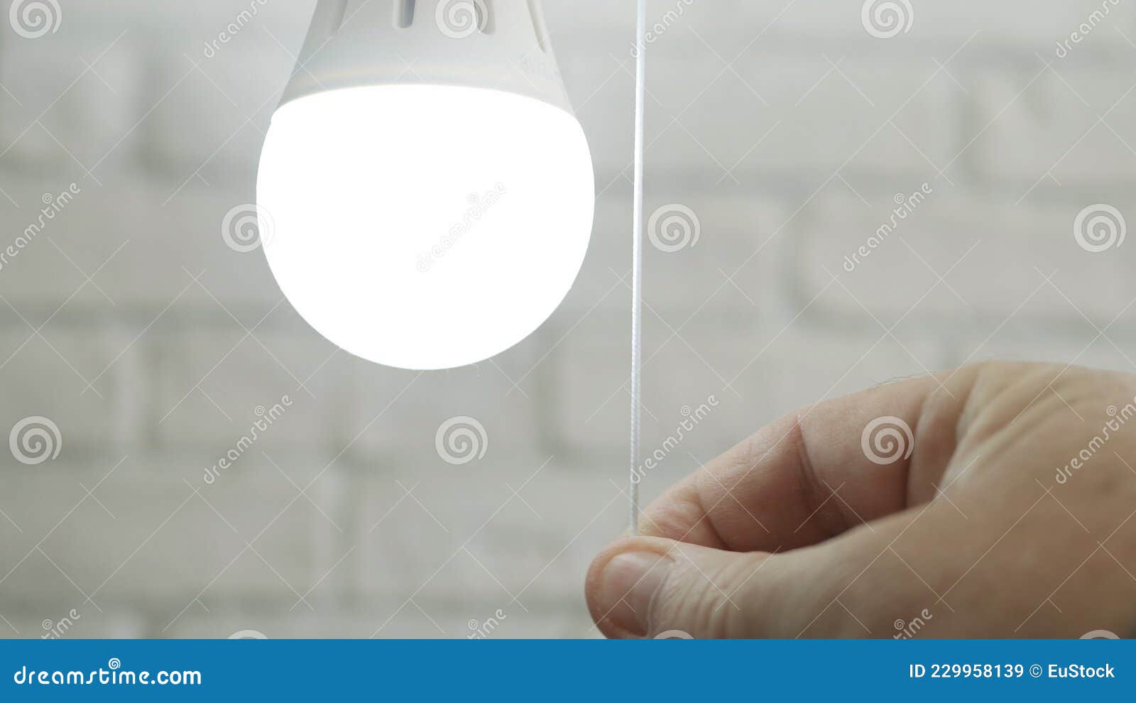 Image with a Man Switching on a LED Bulb in a Room Stock Image - Image ...