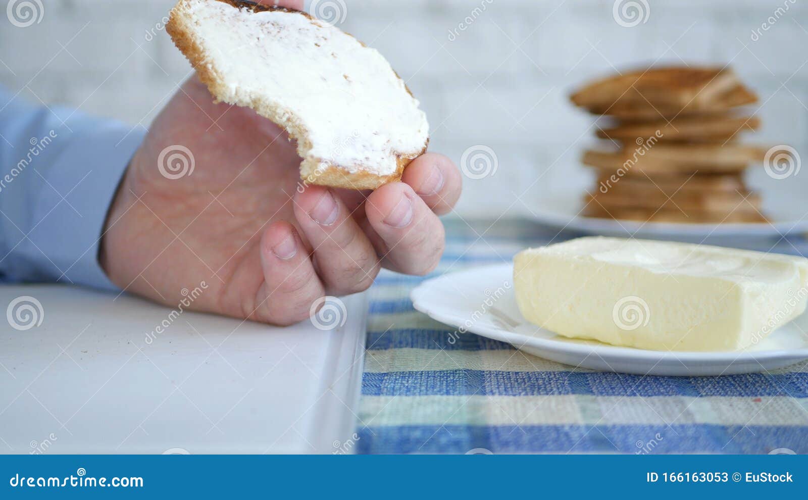 Image with a Men Taking a Bite from a Roasted Slice of Bread with ...