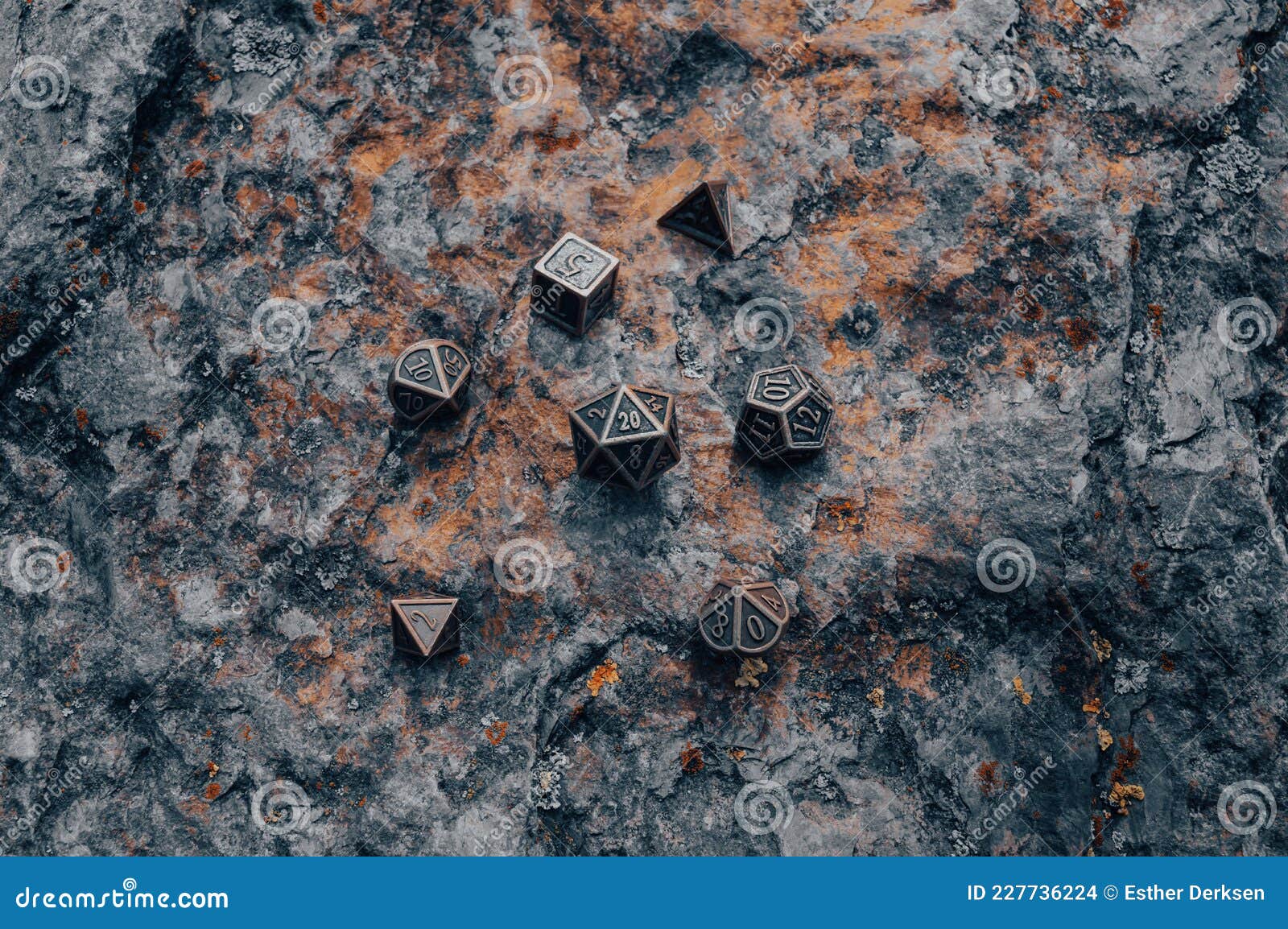 An Image of a Metallic Set of RPG Dice on a Rocky Surface Stock Photo ...