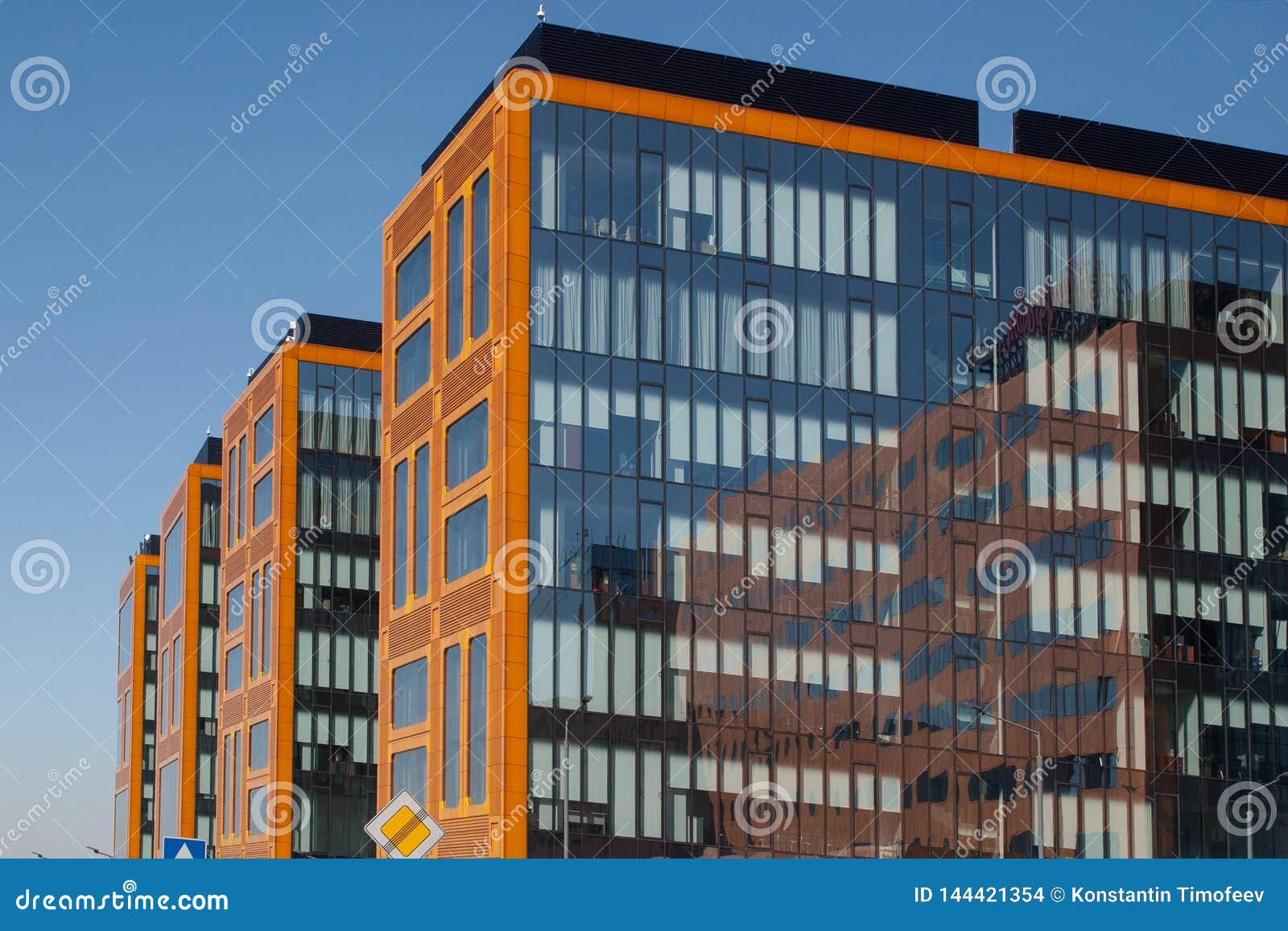 Image of Modern Yellow Office Buildings Against a Blue Sky Stock Photo ...