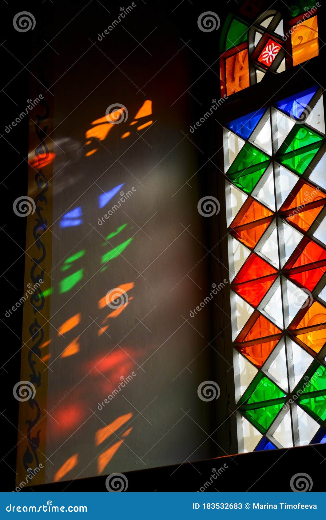 The Image of Multi-colored Stained-glass Window on a Window with a ...