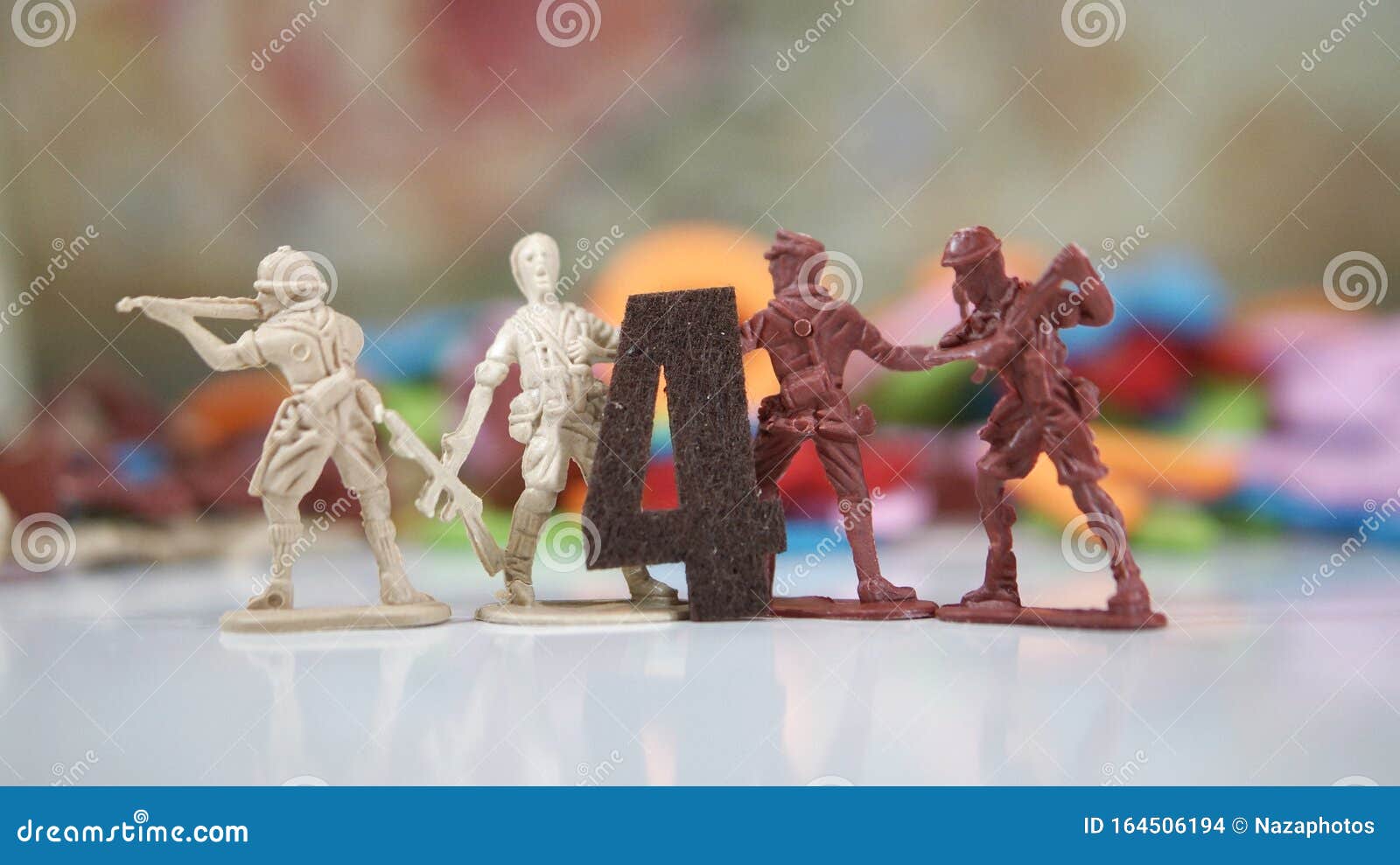 Image of Number 4 with Four Toy Soldiers at Background Stock Photo ...
