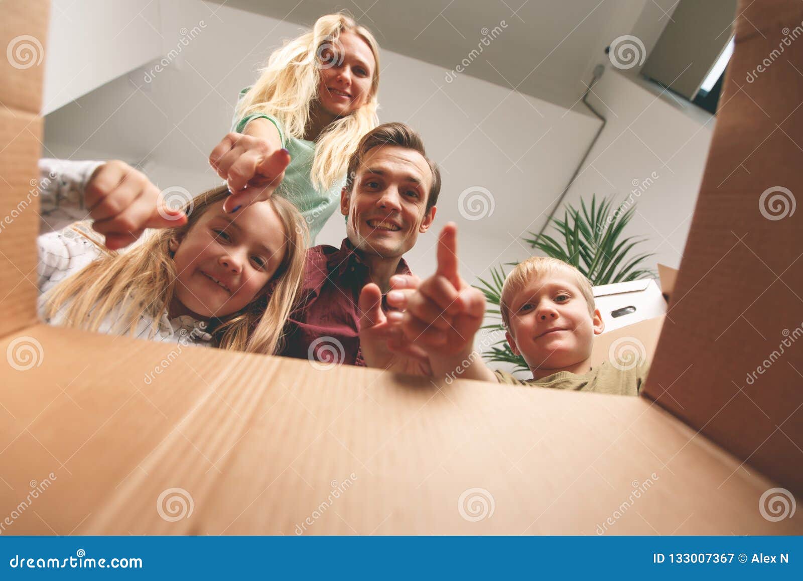 Image of Parents and Children Looking Inside Cardboard Box Stock Image ...