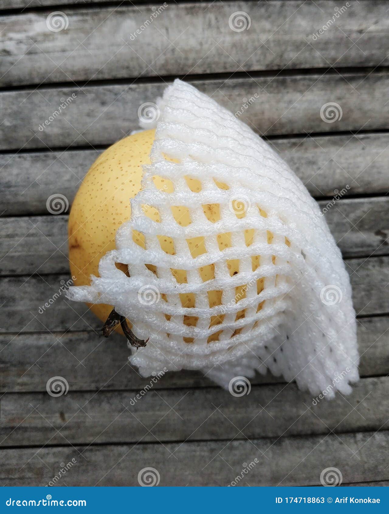 Pear Fruit Wrapped in a Fruit Net on a Black Leather Board Stock Image ...