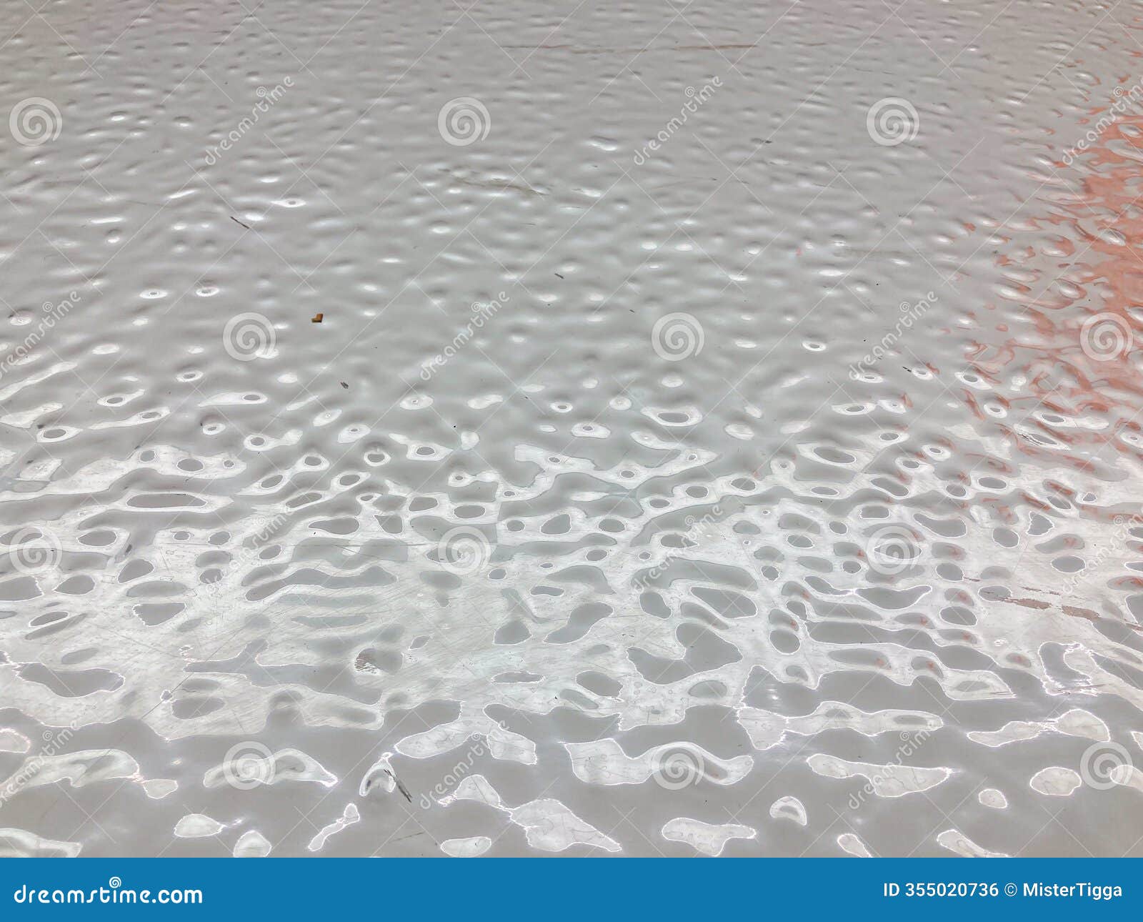 Image Portrays a Close-up, Uniformly Textured Metallic or Glassy ...