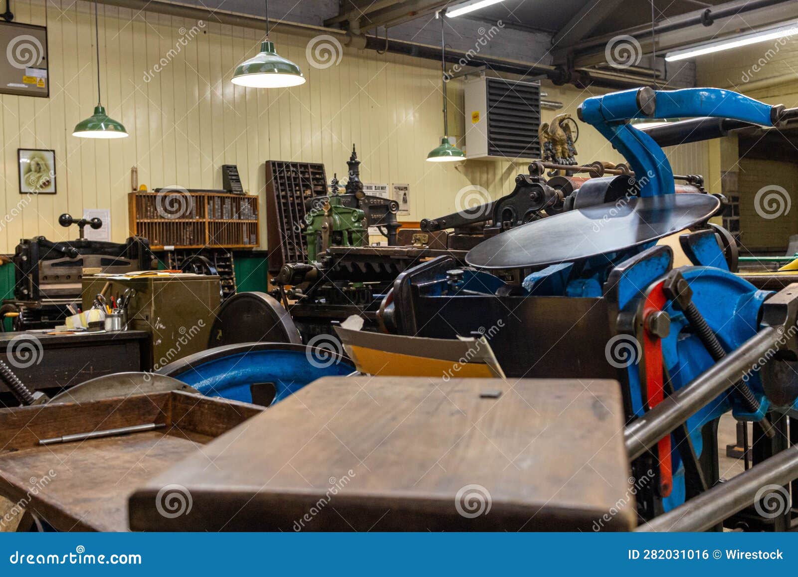 A Room Filled with Lots of Tools and Tables with Many Light Fixtures on ...