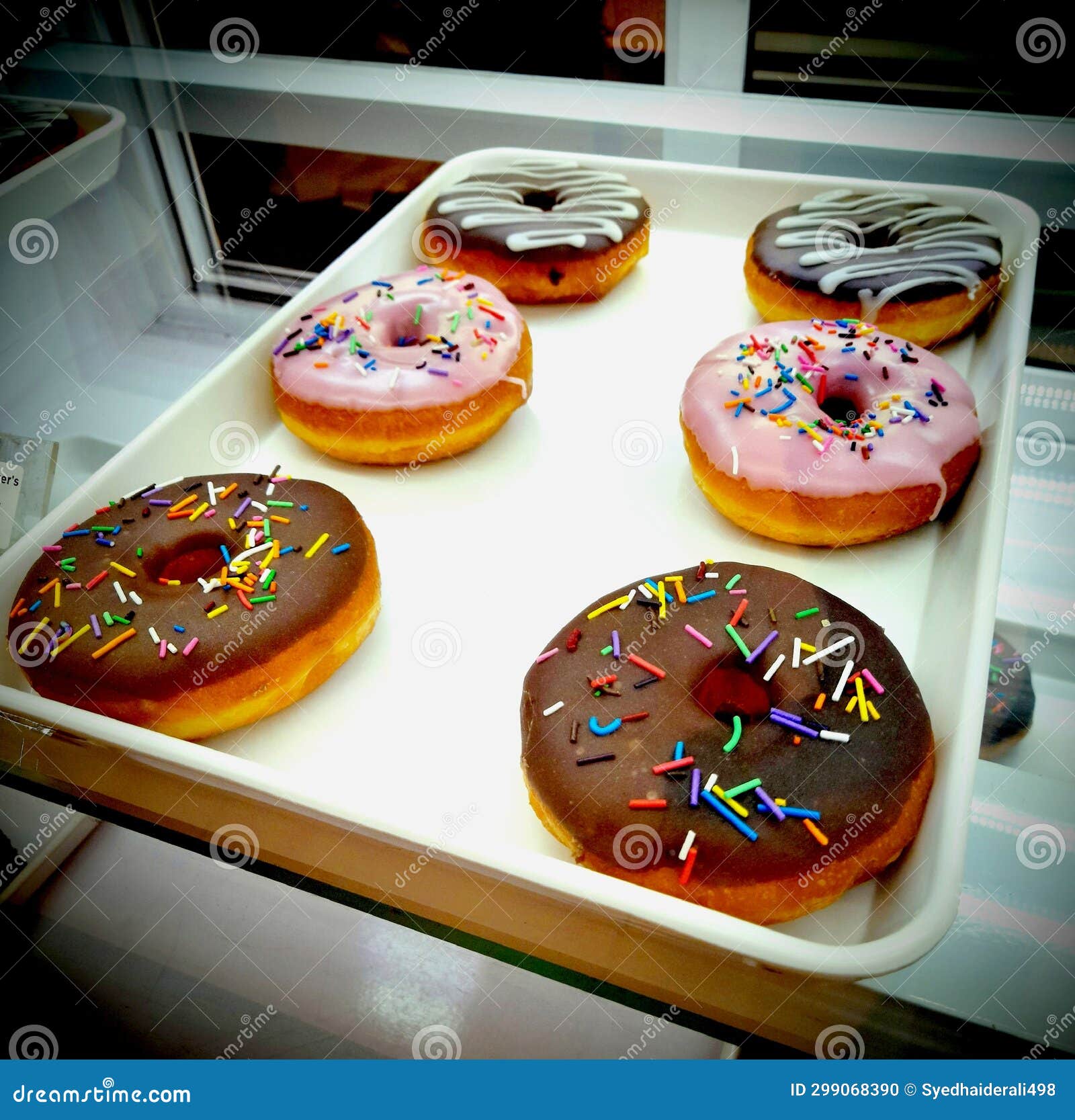 An Array of Freshly Made, Meticulously Decorated Donuts Displayed in a ...