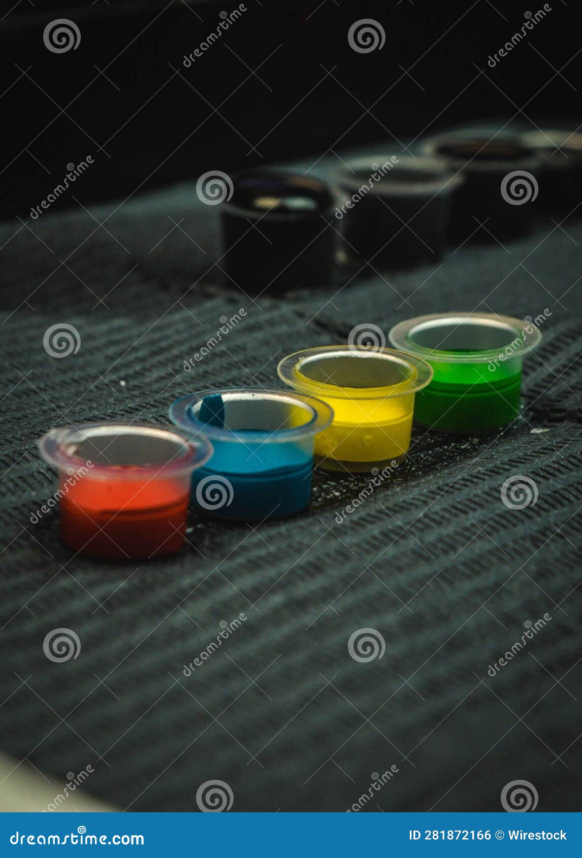 Various Colored Plastic Containers on a Bed Sheet in a Room Stock Photo ...