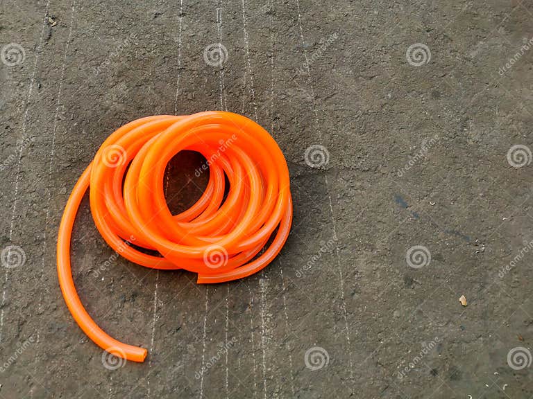 Image of Rubber Hose Coiled on the Ground. Stock Photo - Image of ...