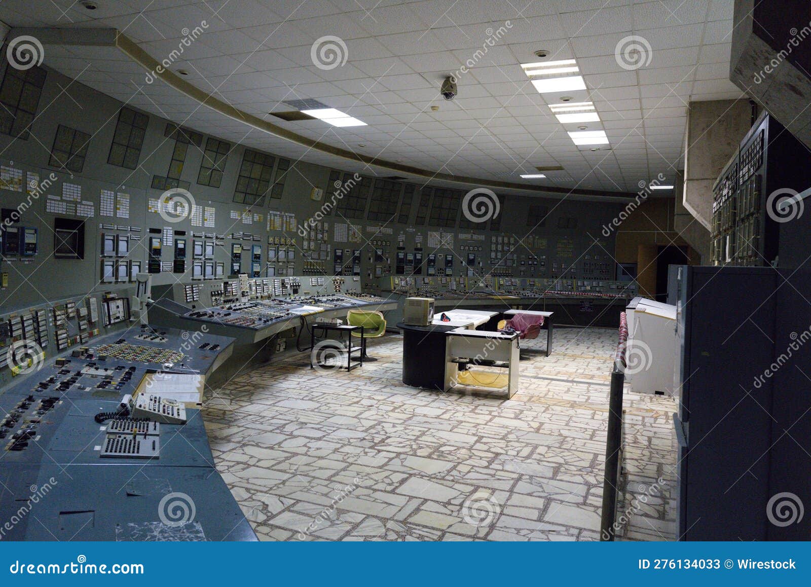 A Large Control Room with a Table and Various Electronics on the Wall ...