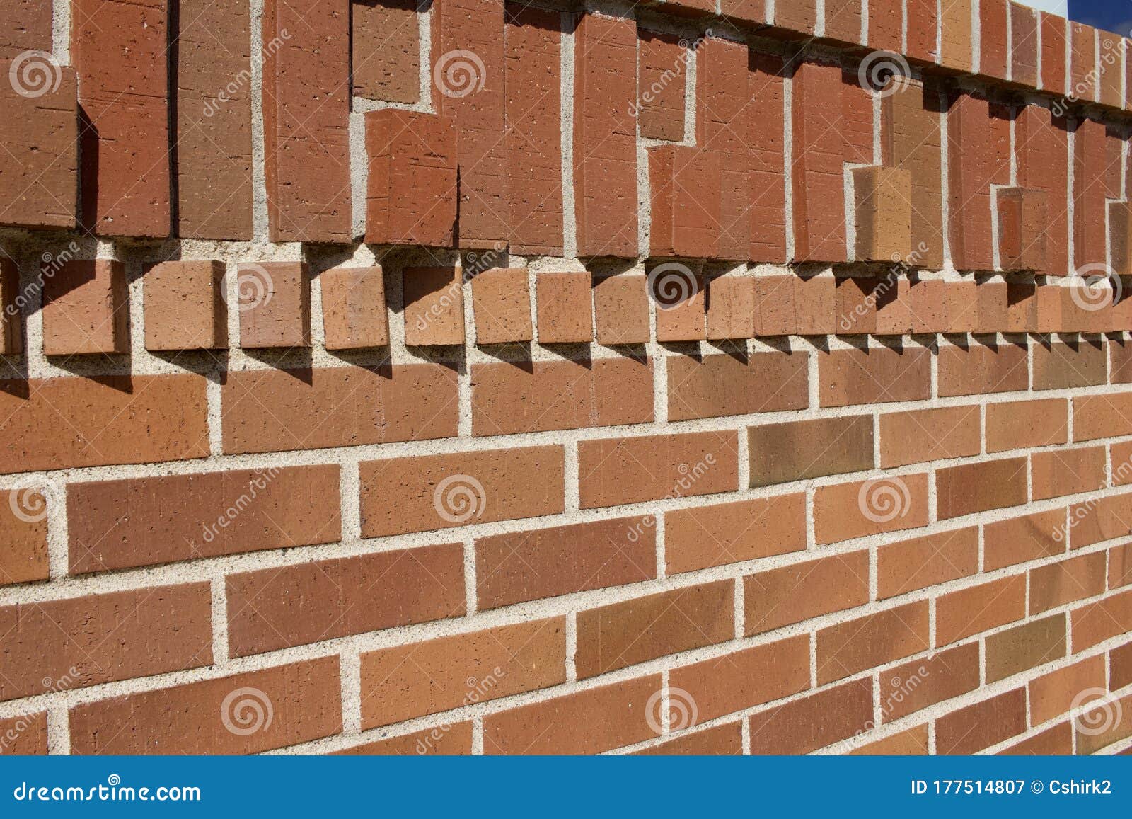 Brown Brick Wall Texture Background with Header of Protruding Bricks in ...